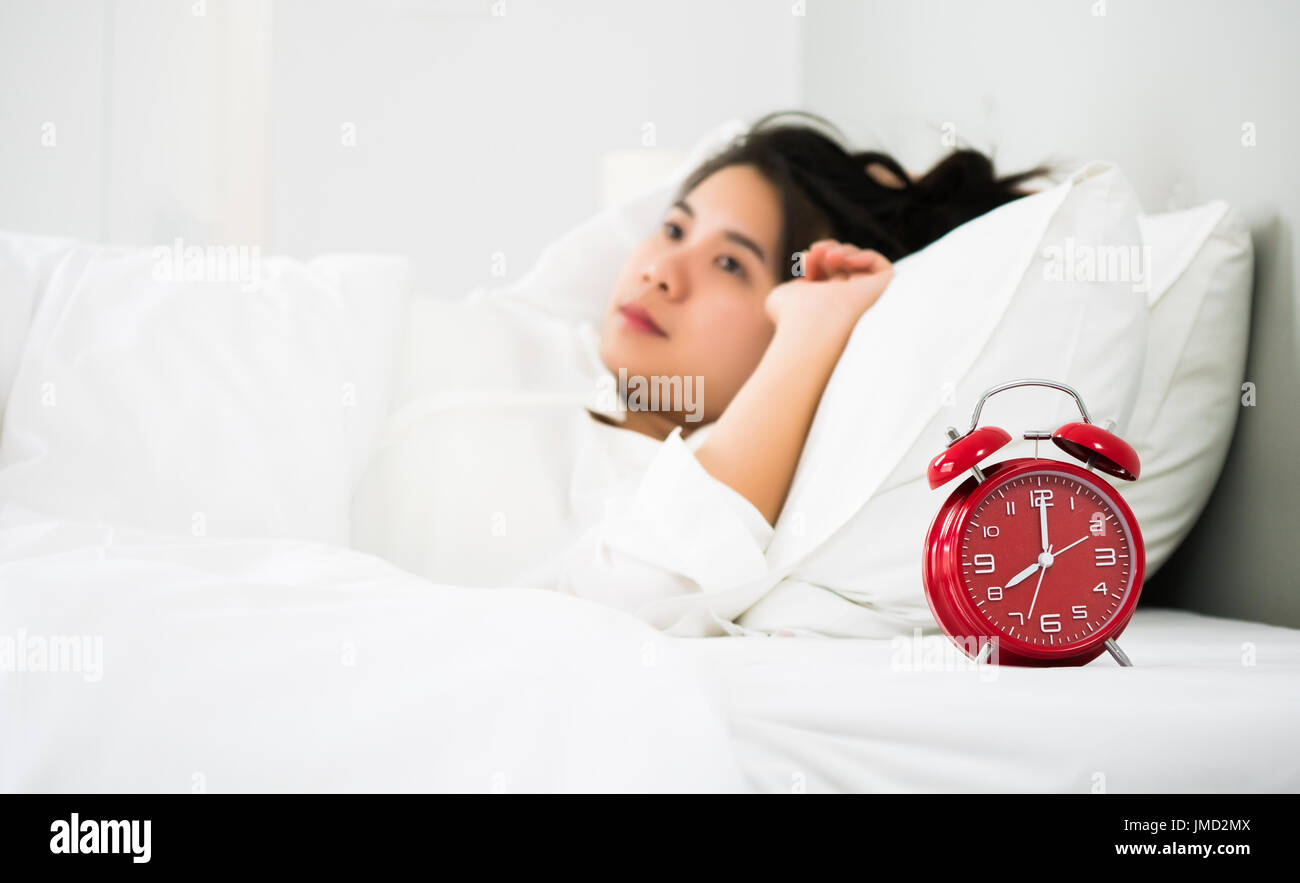 Asian women wake up from sleep. are stretch herself in the morning on ...