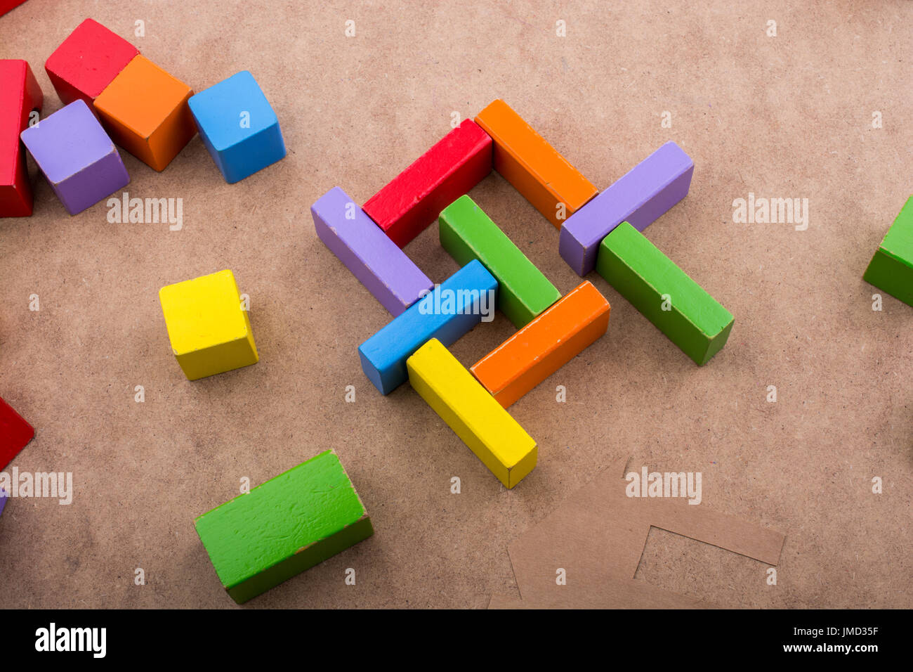 Colorful building blocks on a brown background Stock Photo - Alamy