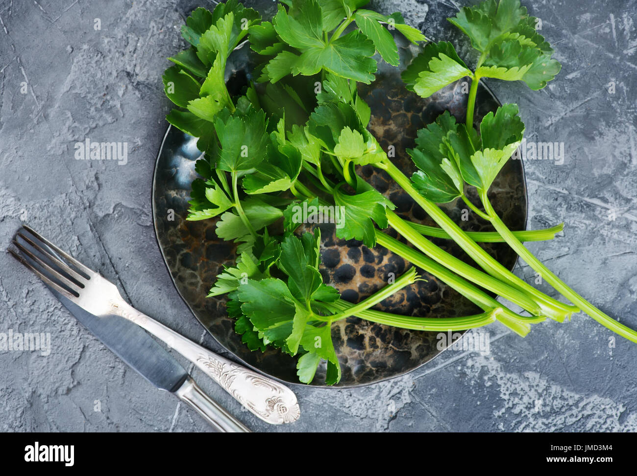 fresh celery on plate and on a table Stock Photo - Alamy