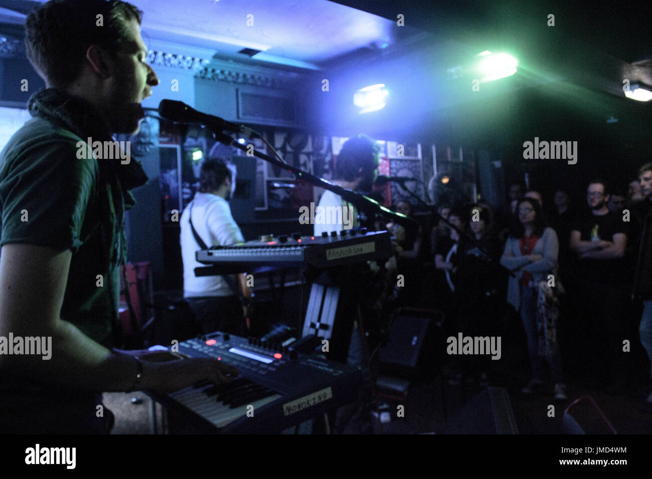 Keyboard player singing on stage Stock Photo - Alamy