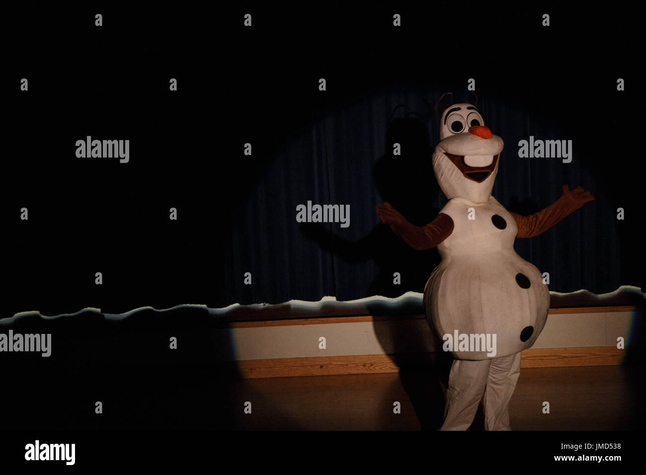 Snowman on stage at children theater play in spotlight Stock Photo - Alamy