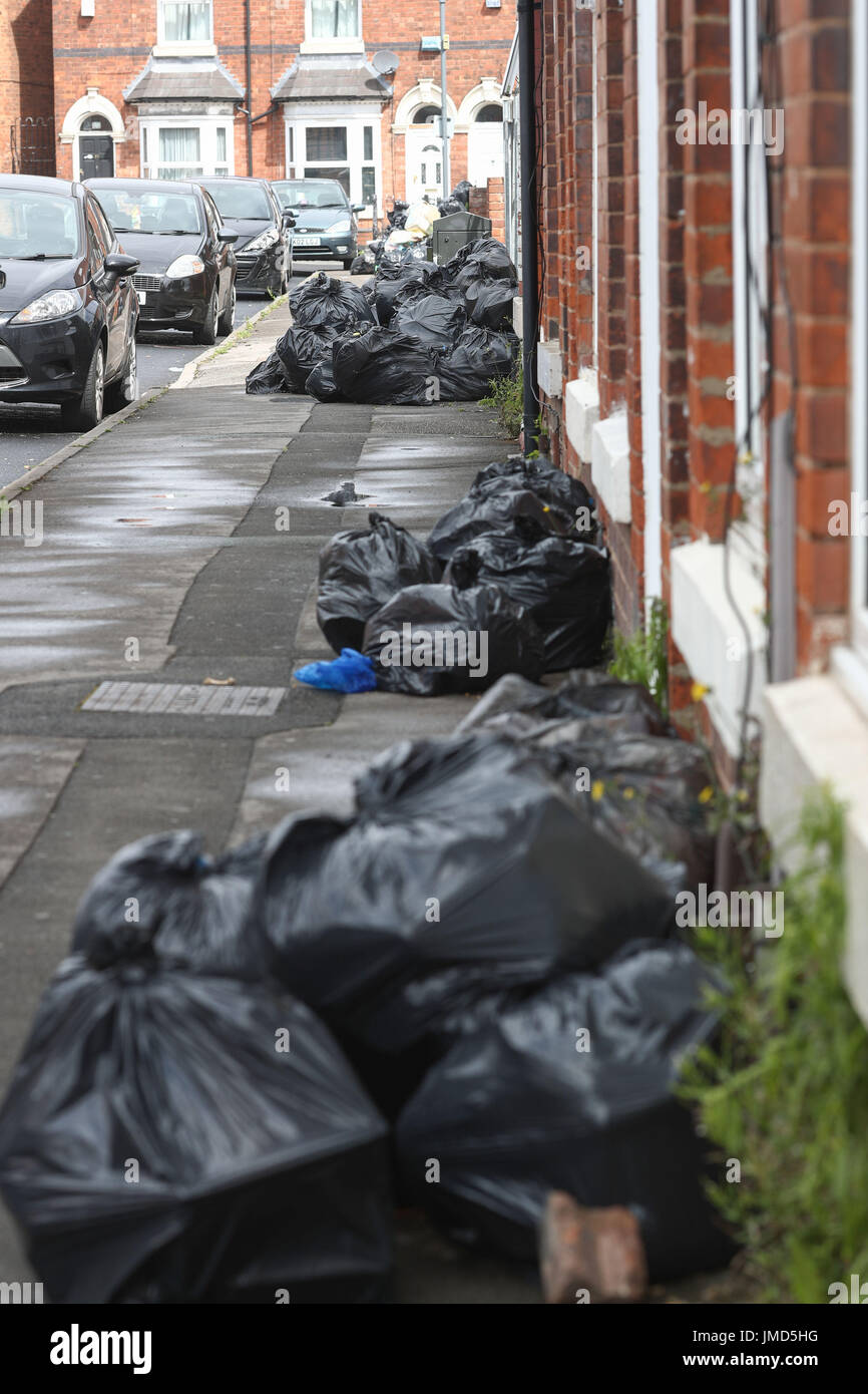 Rubbish bags piled high in tarry road hi-res stock photography and ...