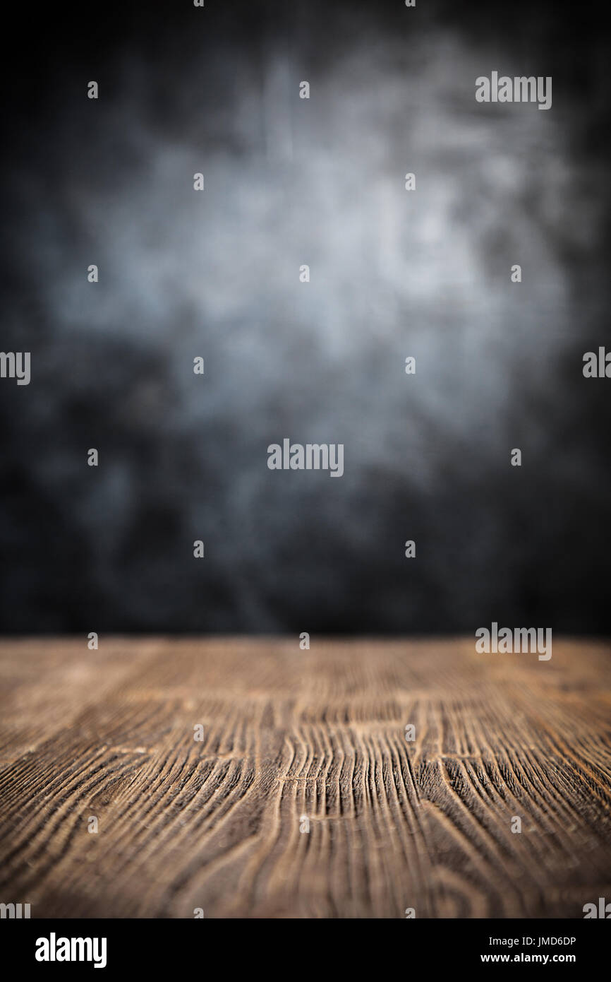 Dark wall and wooden table abstract background Stock Photo - Alamy