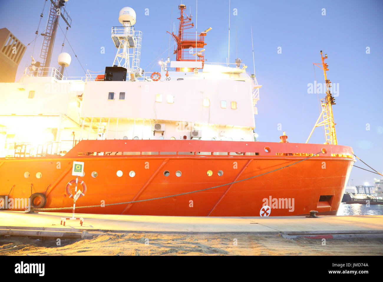 big red ship on the seashore side Stock Photo - Alamy
