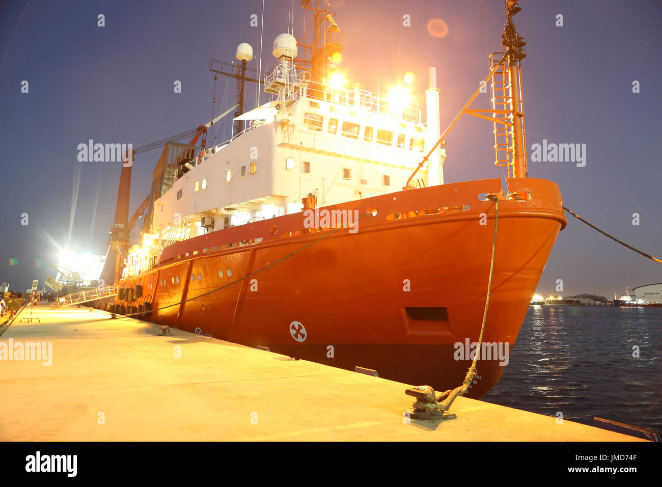 big red ship on the seashore side Stock Photo - Alamy