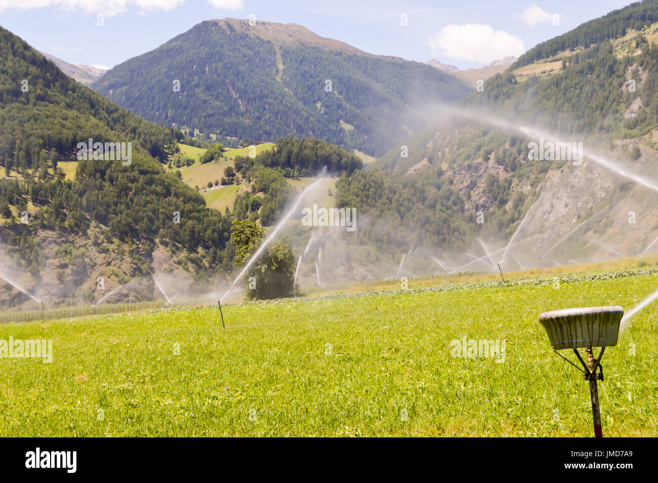 Automatic irrigation of crop fields in dolomites in Italy Stock Photo ...