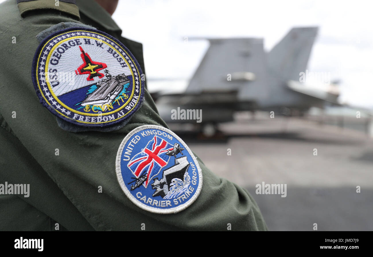 Badges on the sleeve of Royal Navy's Lieutenant Commander James Capps ...