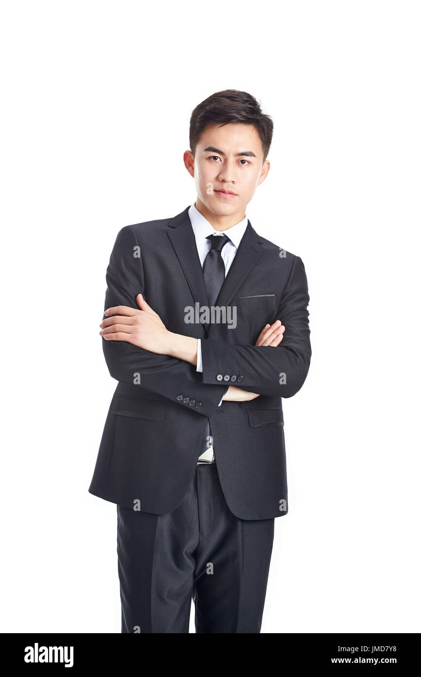 studio portrait of a young asian businessman in formal wear, arms ...