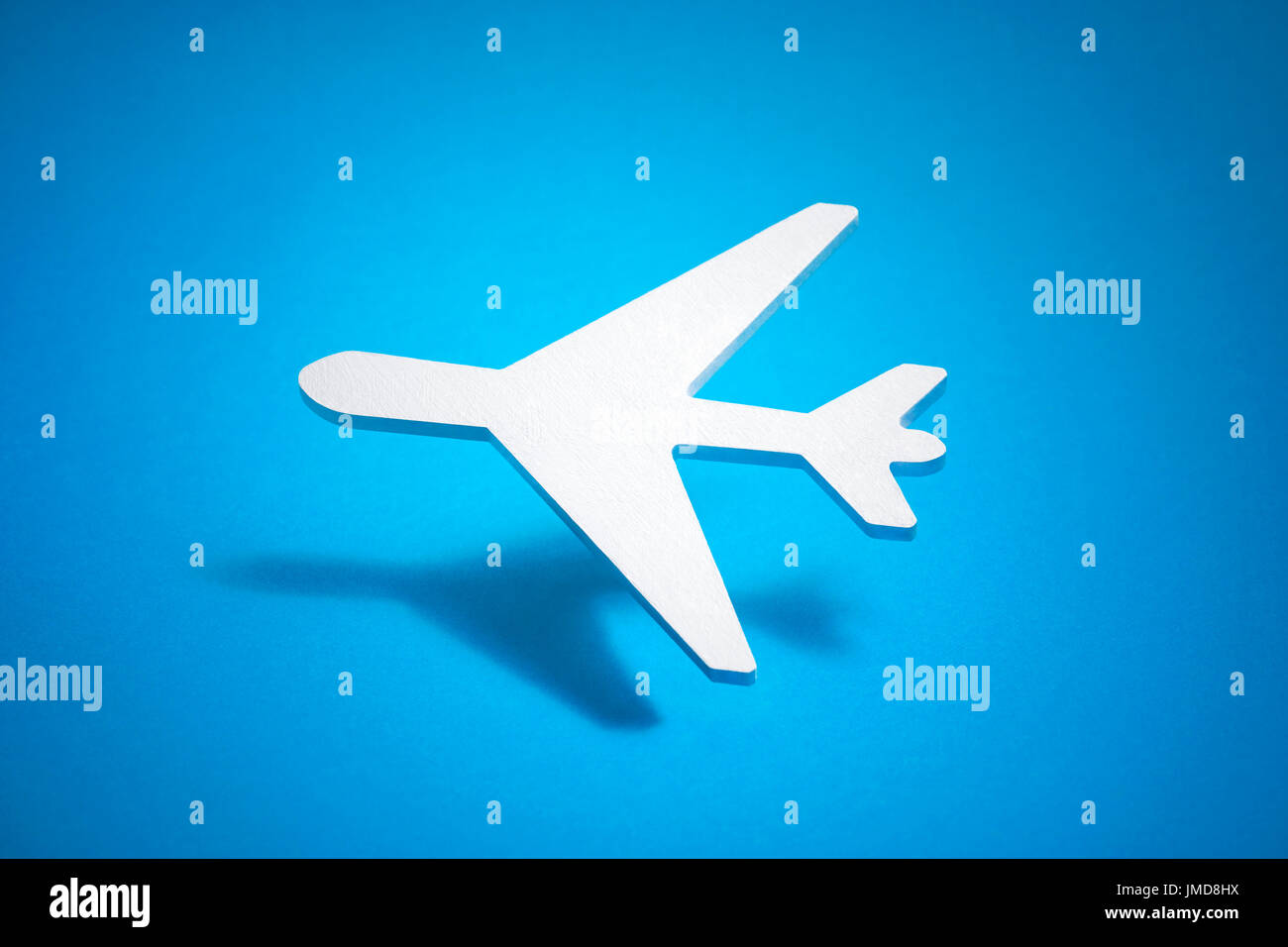 Airplane shape over blue background Stock Photo - Alamy