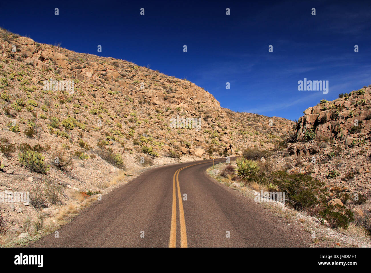 A scenic desert road cuts through the vast Big Bend National Park in ...