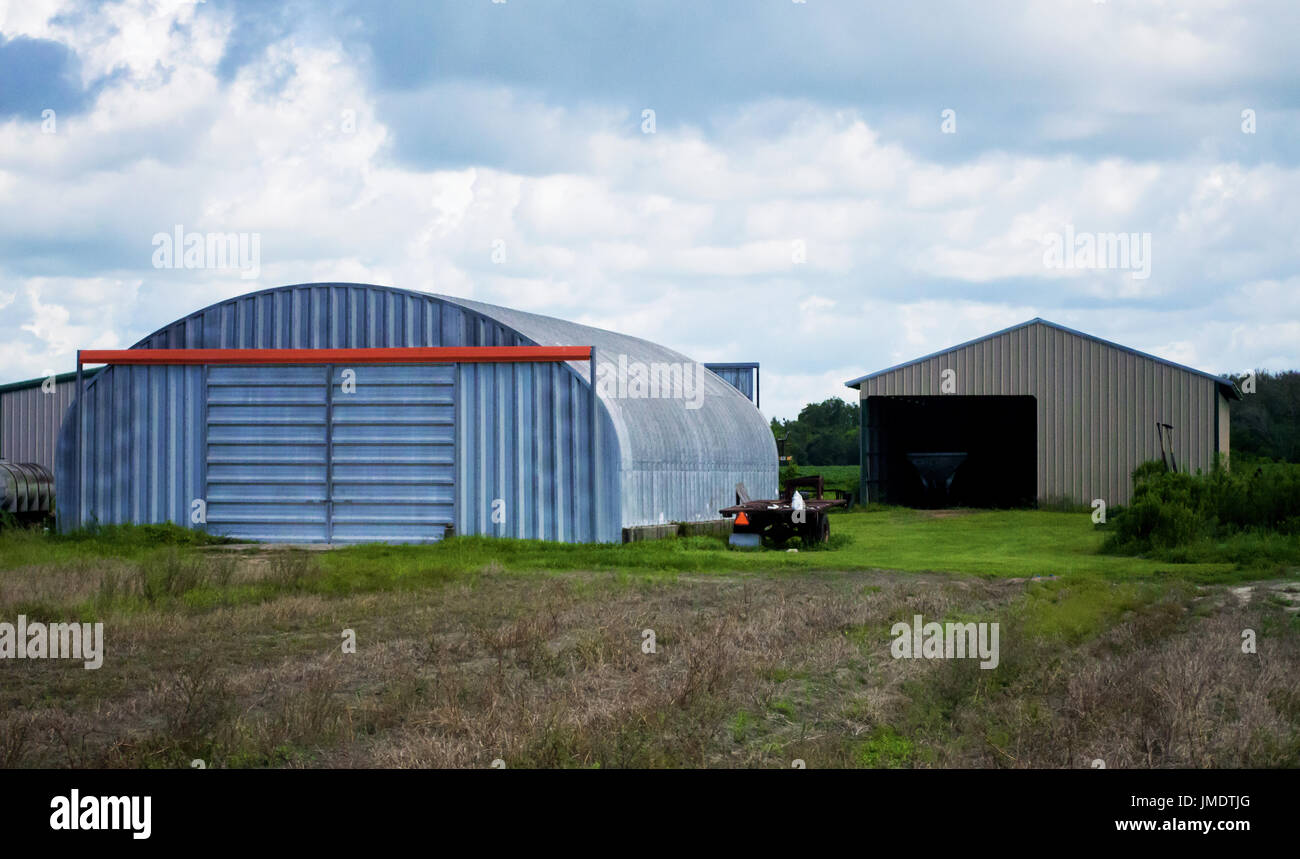 A complex of farm building on a bright blue sky Stock Photo - Alamy