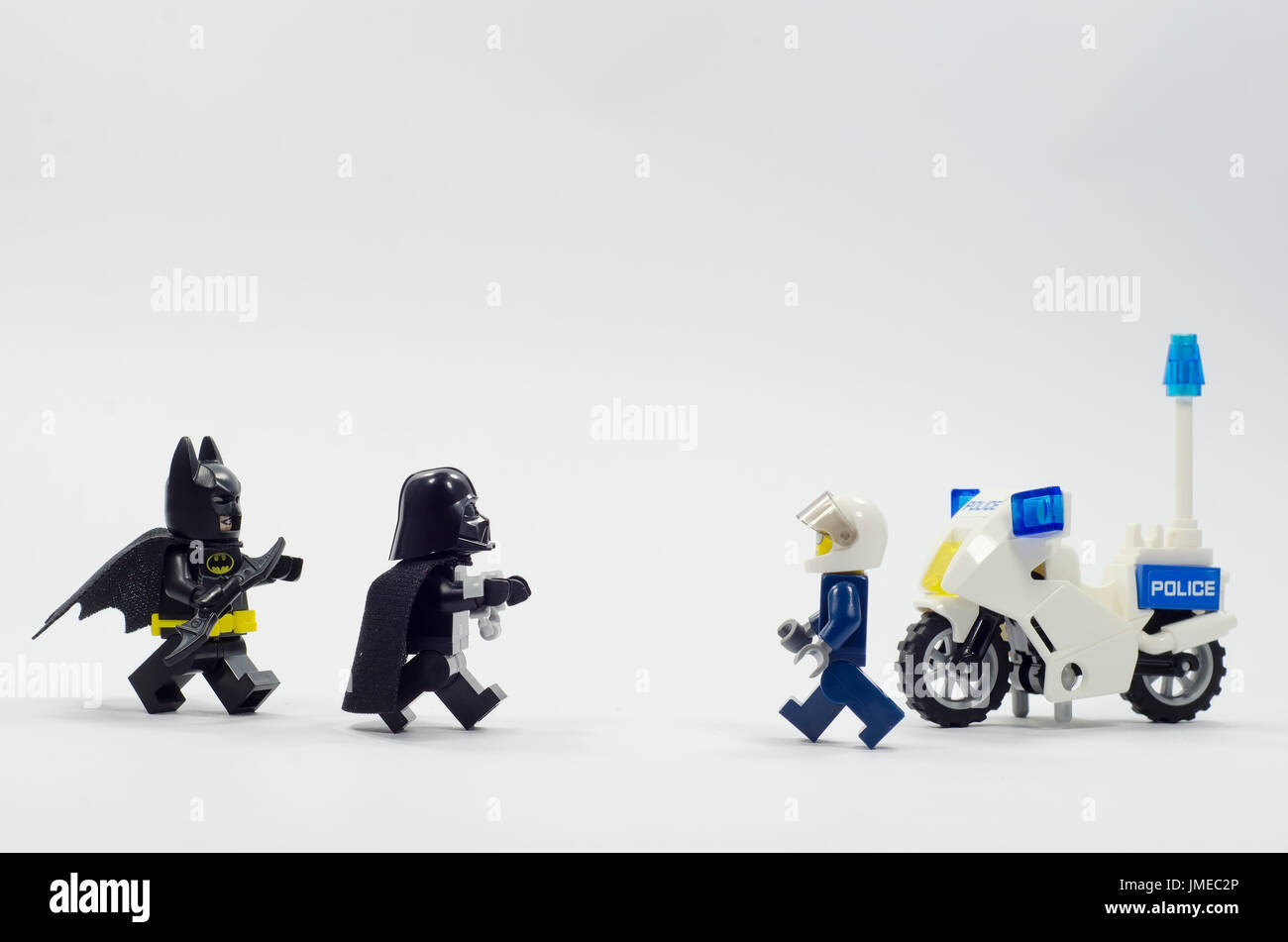 lego batman hand over darth vader to policeman Stock Photo - Alamy