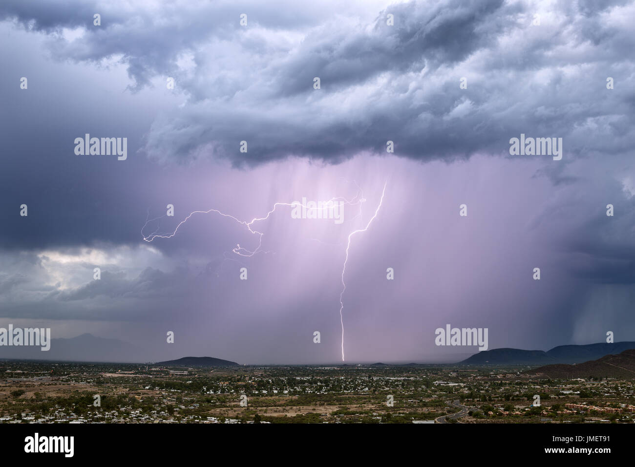 Heavy rain and lightning strike in a thunderstorm over Tucson, Arizona ...