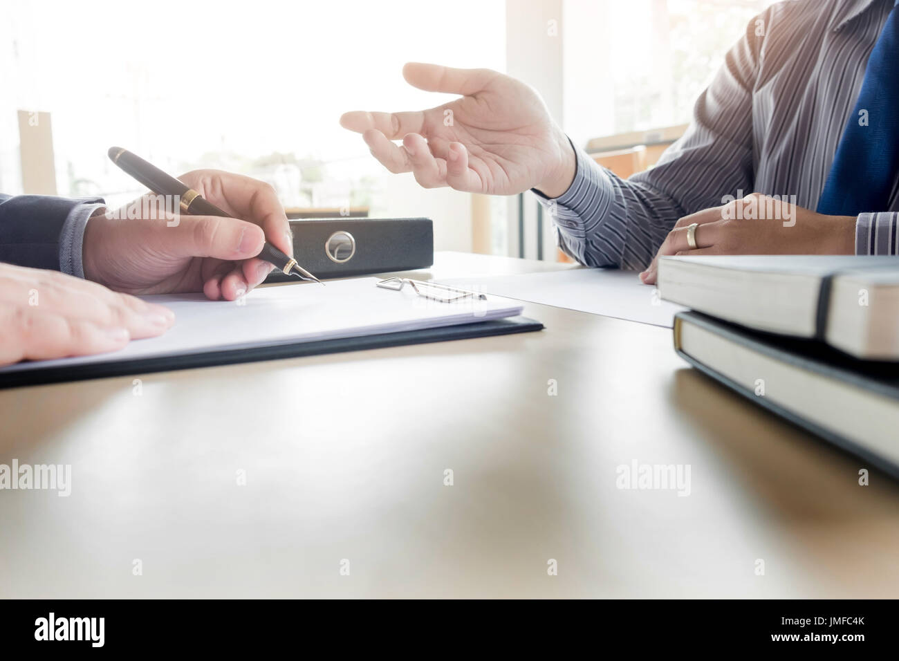 Businessman conducting an interview with businessman in an office Stock ...