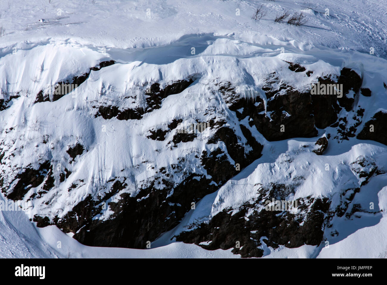 Rocks, cliffs on a mountain slope. Winter, snow and snow-pack Stock ...