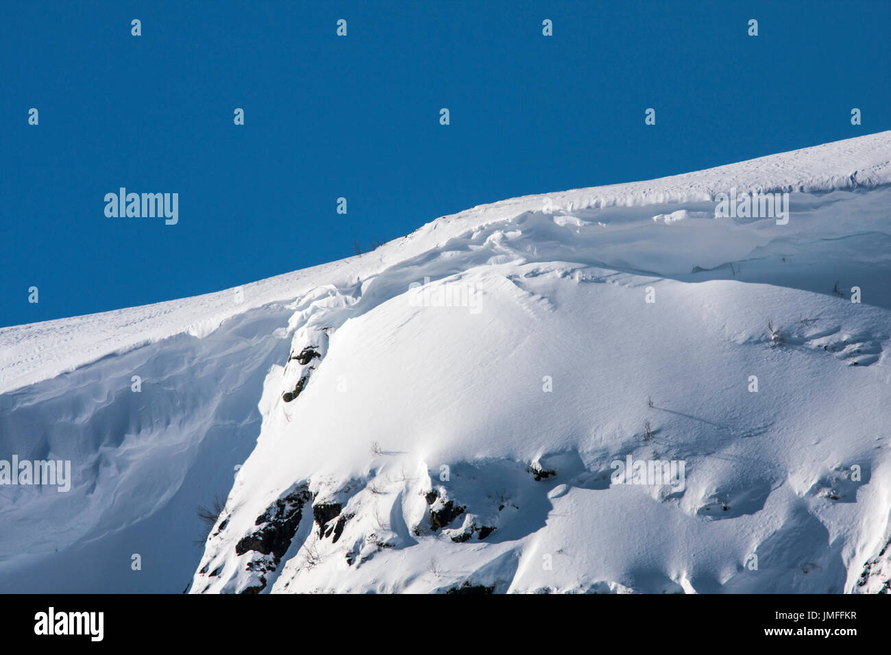 Rocks, cliffs on a mountain slope. Winter, snow and snow-pack Stock ...