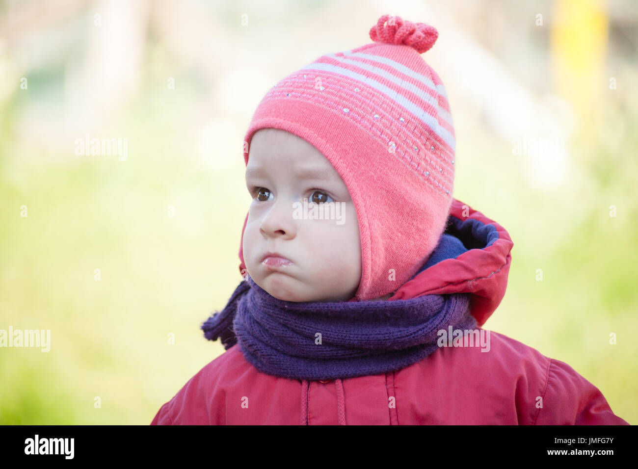 brown eyed girl child is looking left with red jumper Stock Photo - Alamy