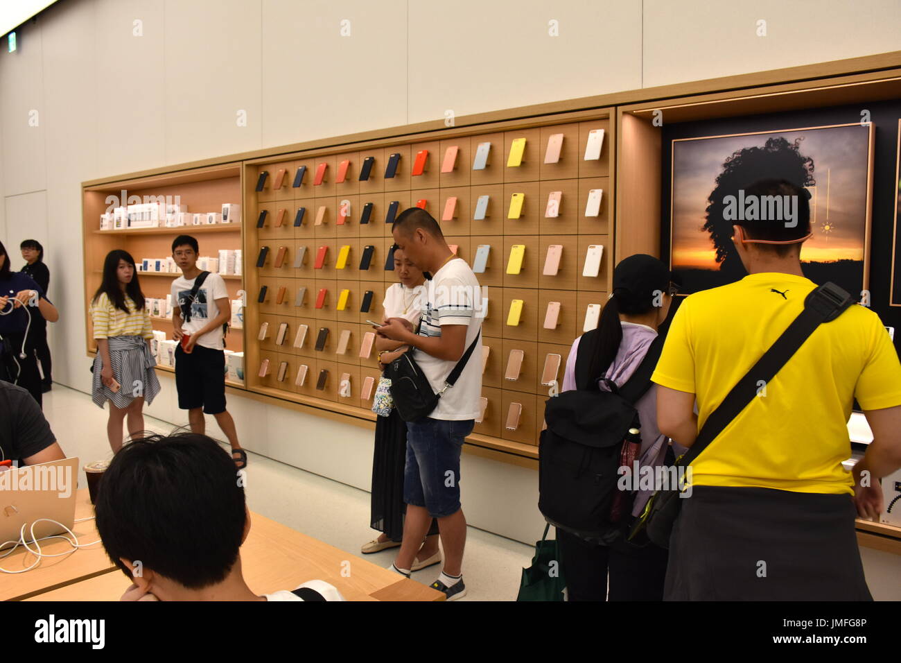 Customers exploring the Apple store at the grand opening of the 1st ...