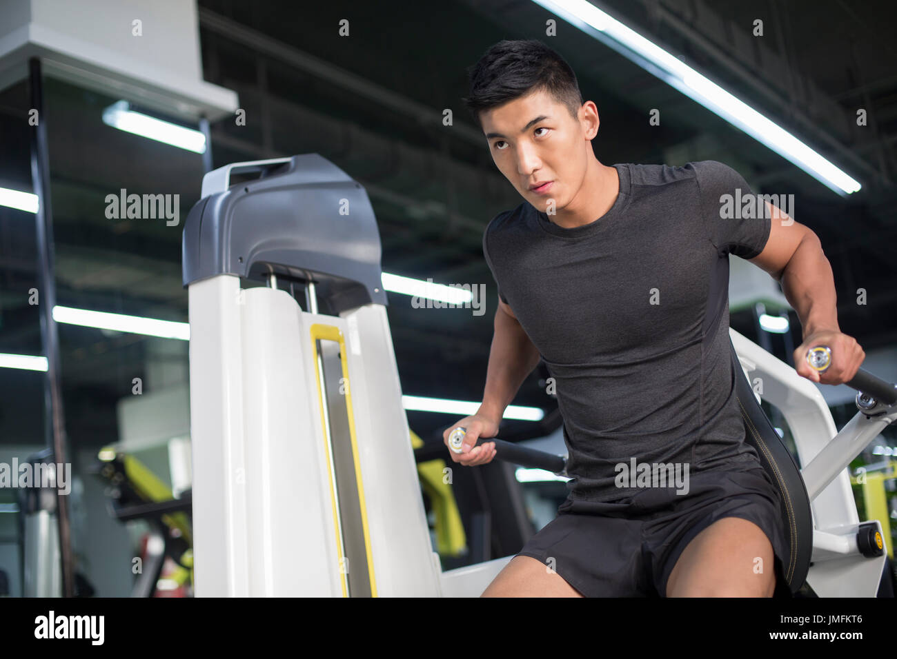 Young Chinese man exercising at gym Stock Photo - Alamy