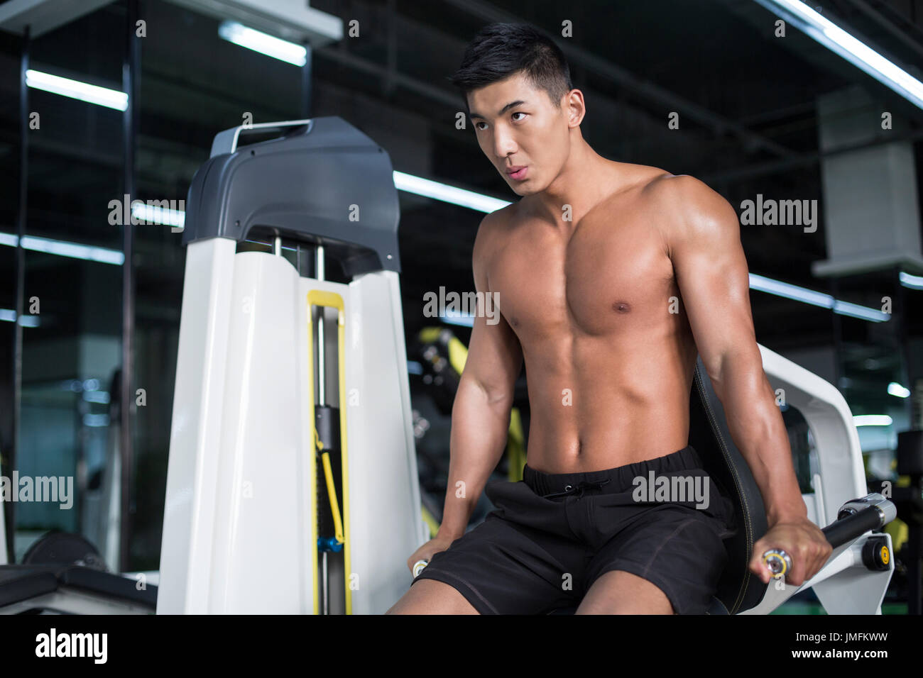 Young Chinese man exercising at gym Stock Photo - Alamy