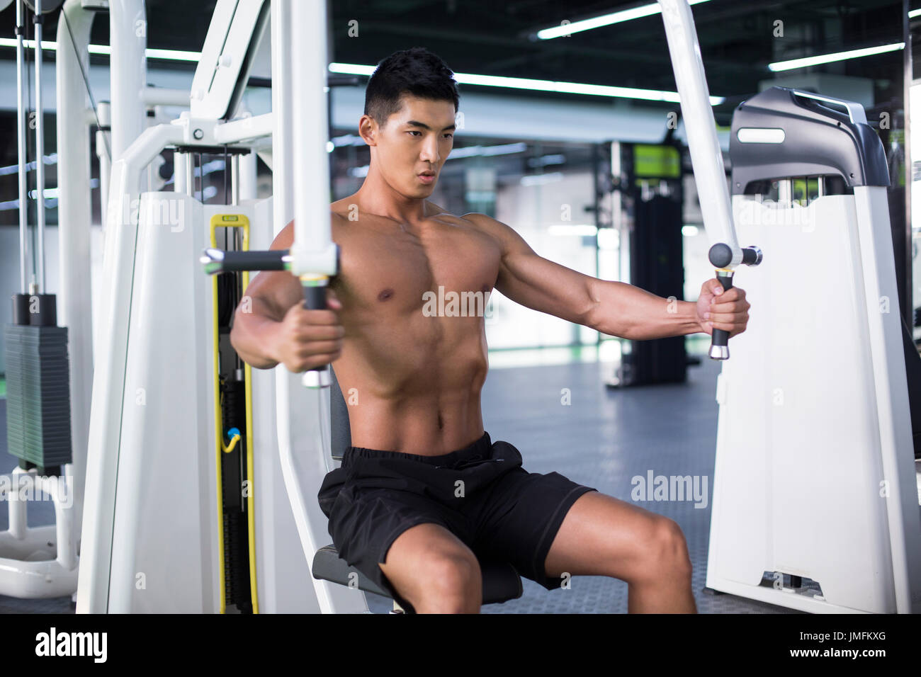 Young Chinese man exercising at gym Stock Photo - Alamy