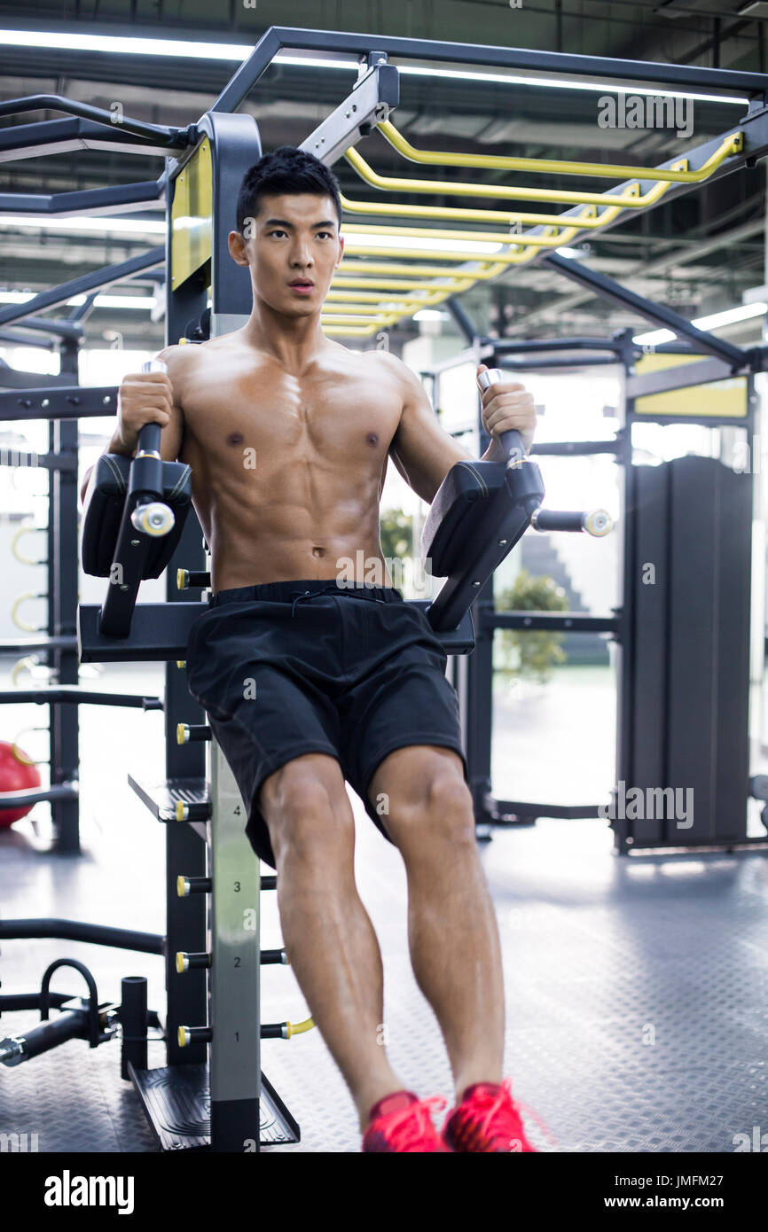 Young Chinese man exercising at gym Stock Photo - Alamy
