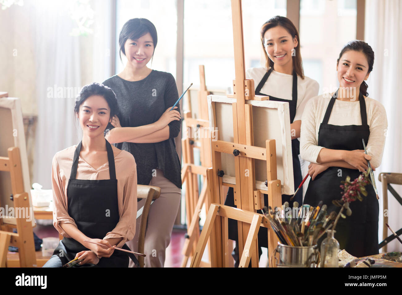 Art teacher with young women in studio Stock Photo - Alamy