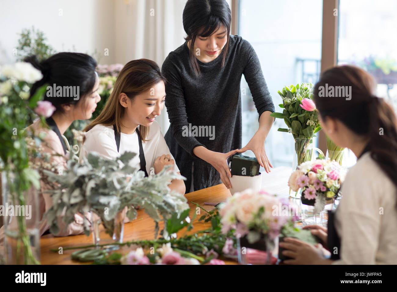 Young women learning flower arrangement Stock Photo - Alamy
