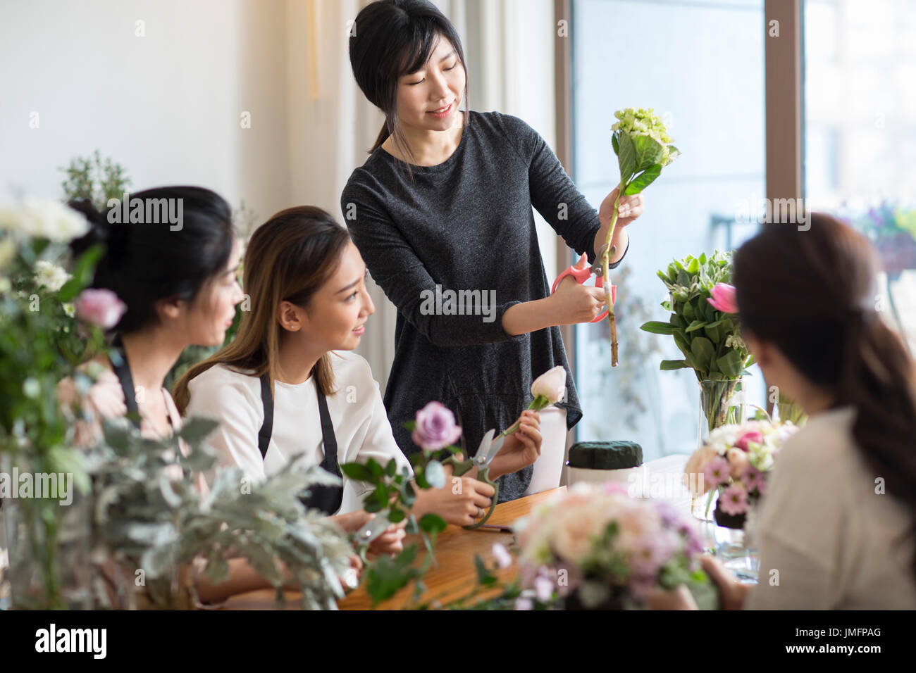 Young women learning flower arrangement Stock Photo - Alamy