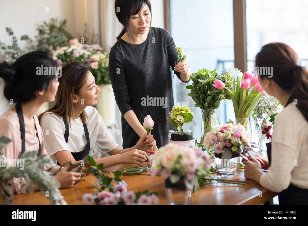 Young women learning flower arrangement Stock Photo - Alamy