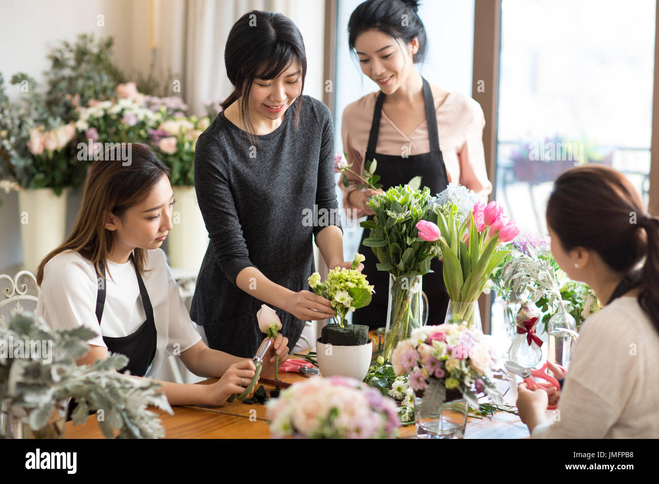 Young women learning flower arrangement Stock Photo - Alamy