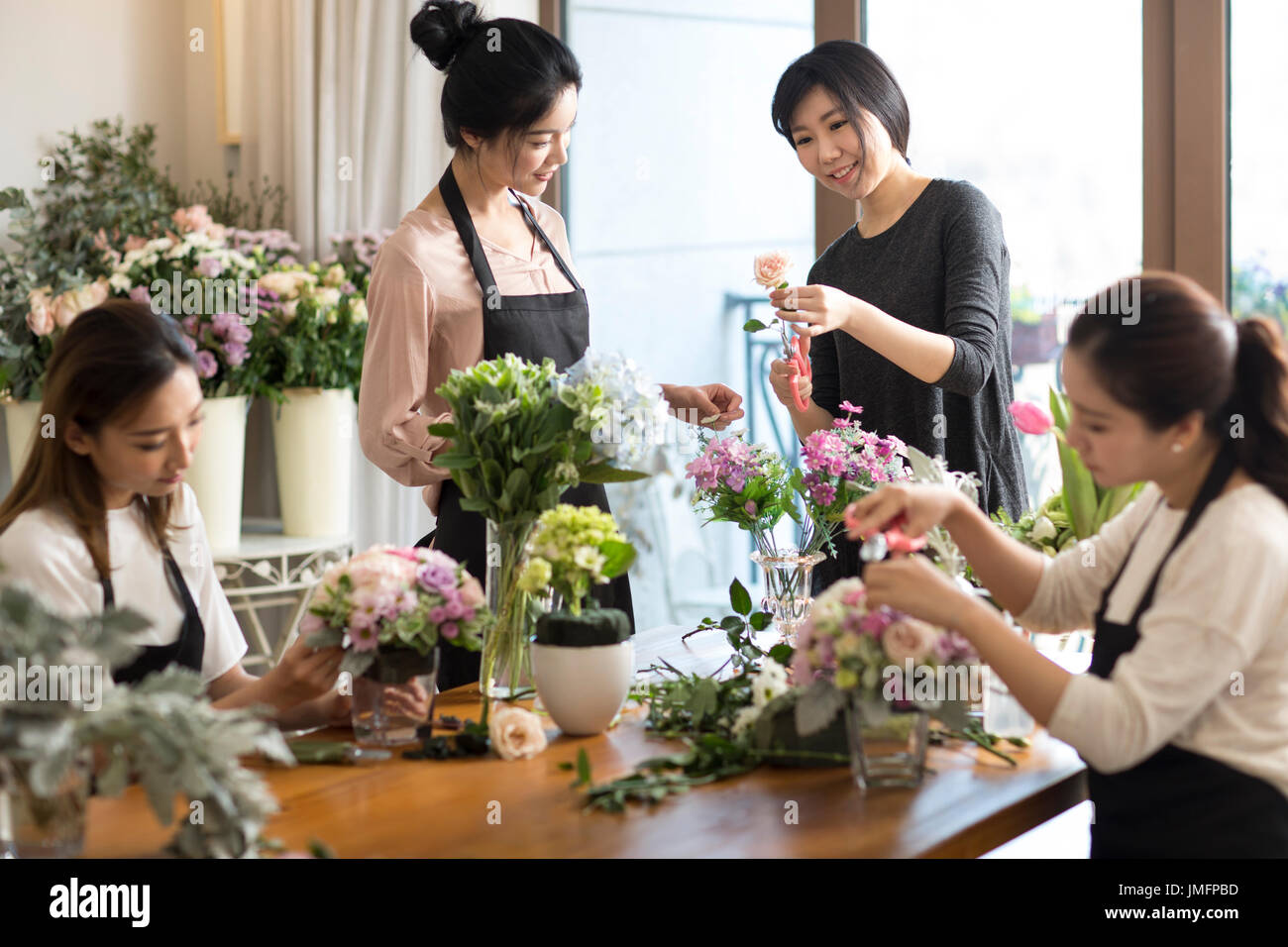 Young women learning flower arrangement Stock Photo - Alamy