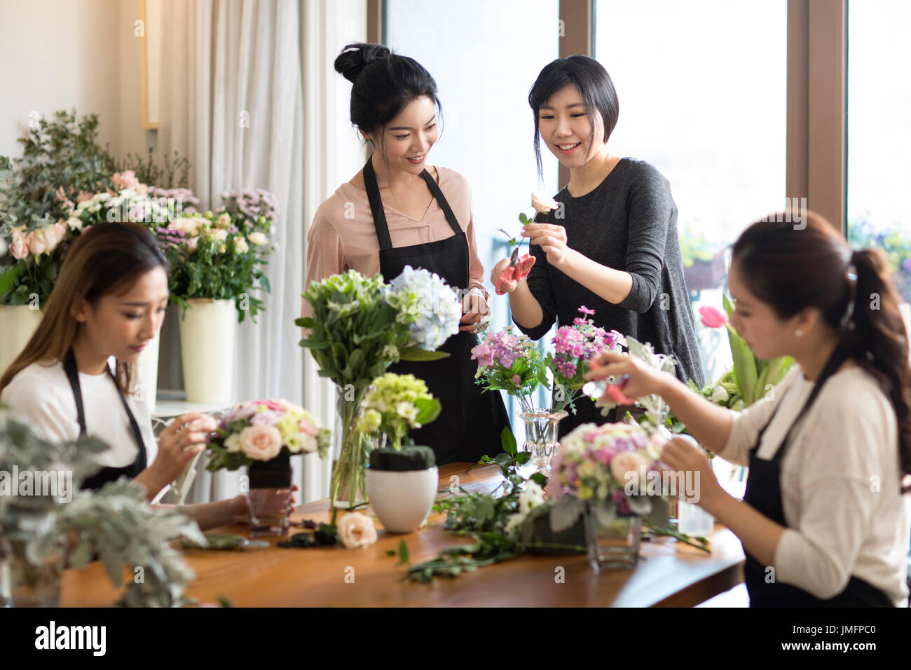 Young women learning flower arrangement Stock Photo - Alamy