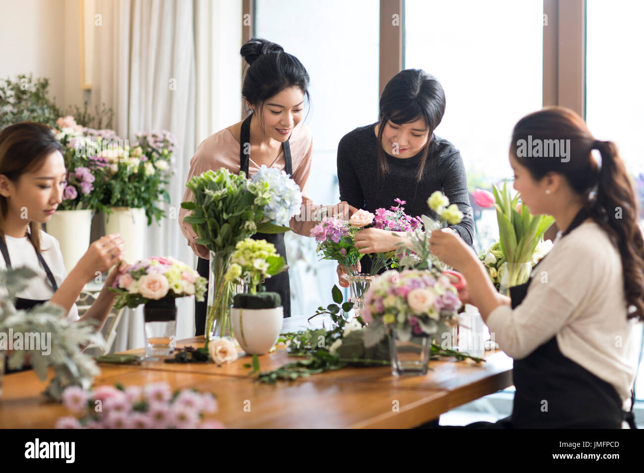Young women learning flower arrangement Stock Photo - Alamy