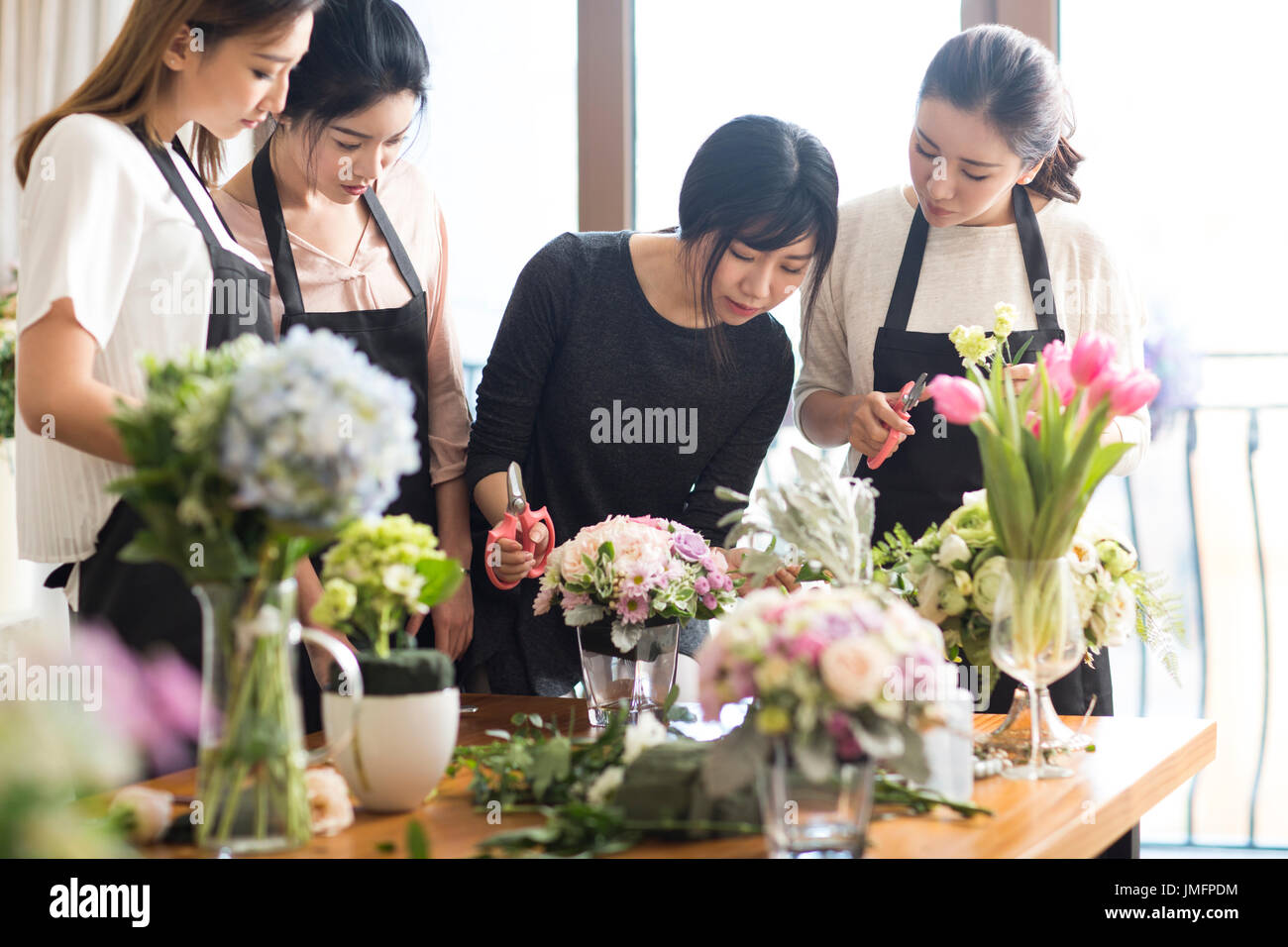Young women learning flower arrangement Stock Photo - Alamy