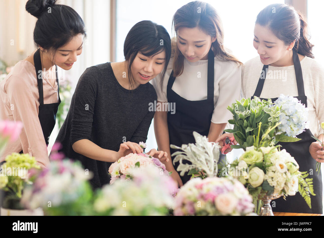 Young women learning flower arrangement Stock Photo - Alamy