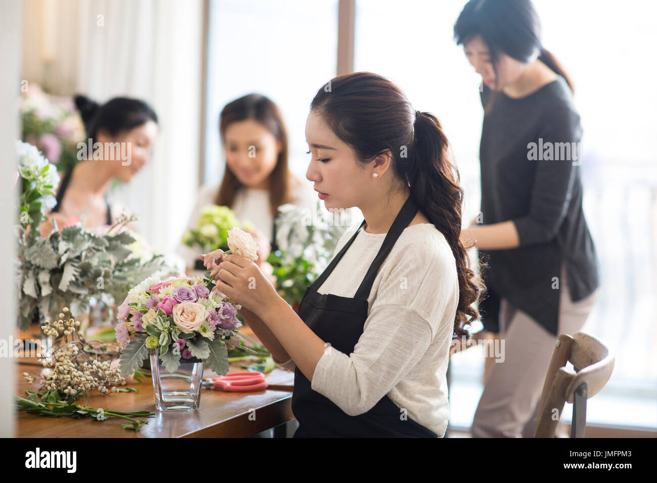 Young women learning flower arrangement Stock Photo - Alamy