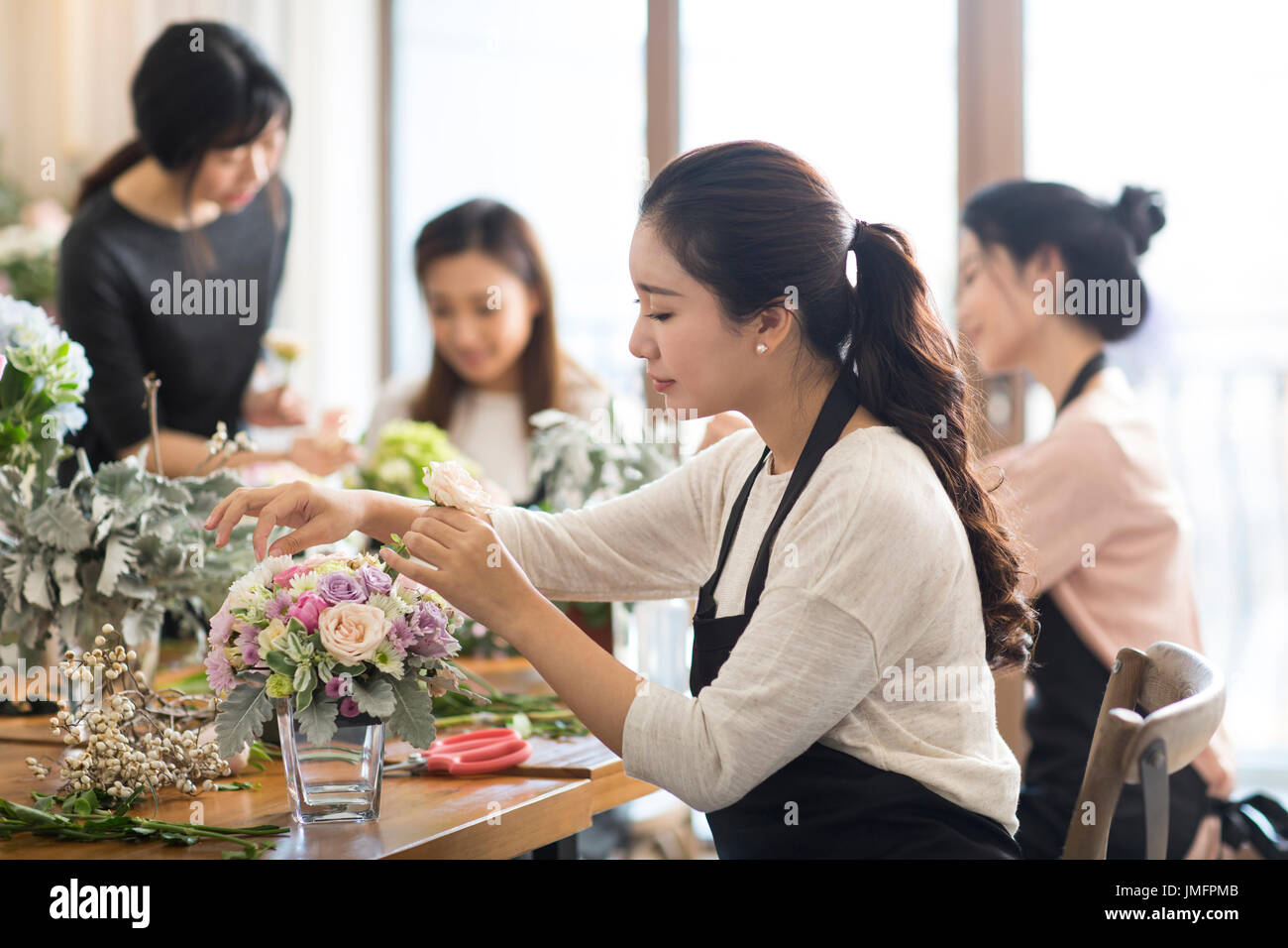 Young women learning flower arrangement Stock Photo - Alamy