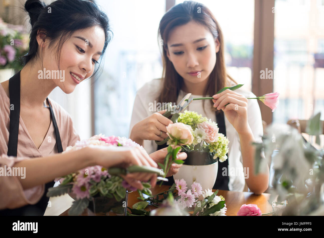 Young women learning flower arrangement Stock Photo - Alamy