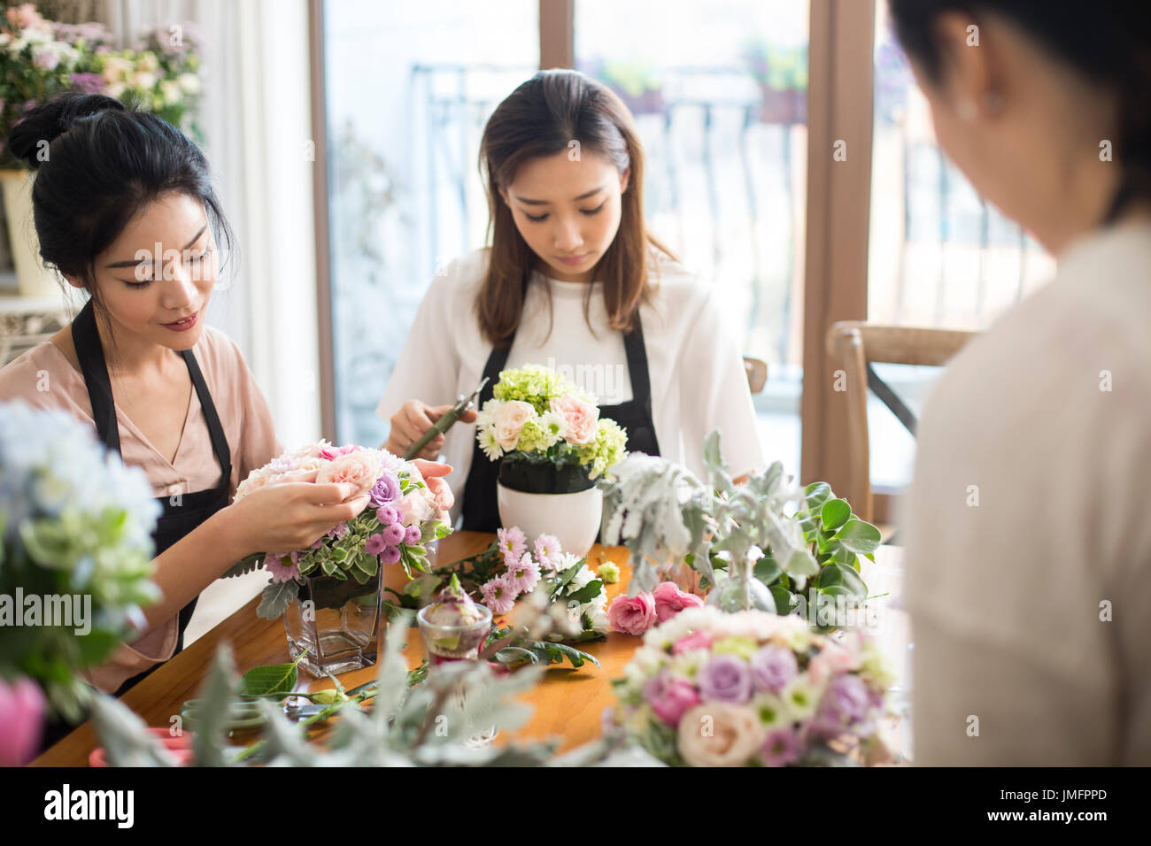 Young women learning flower arrangement Stock Photo - Alamy