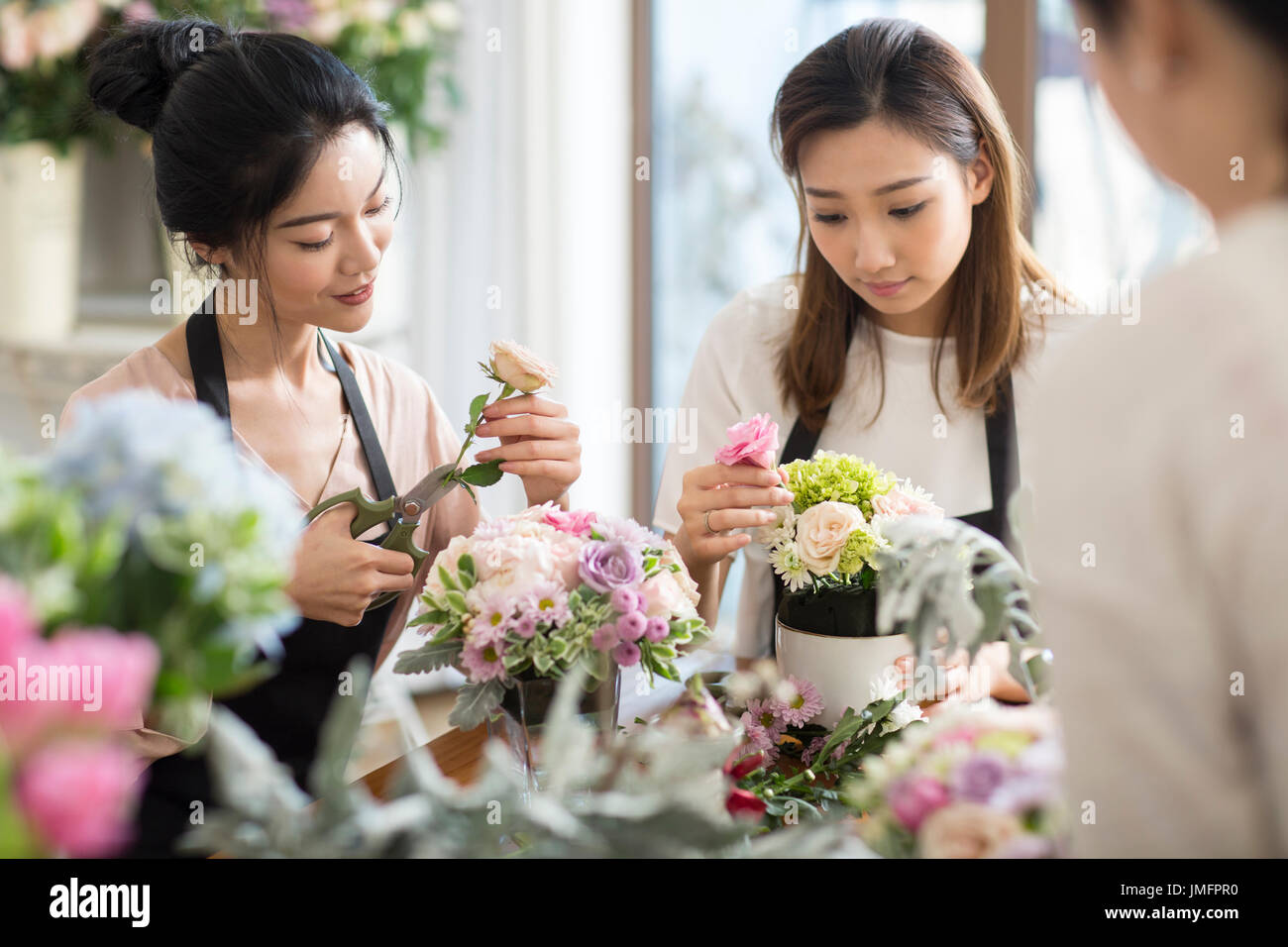 Young women learning flower arrangement Stock Photo - Alamy