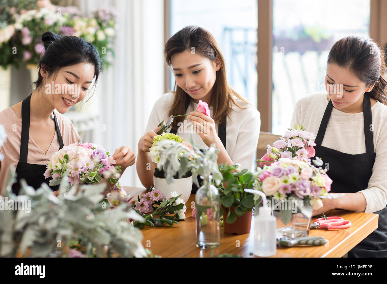 Young women learning flower arrangement Stock Photo - Alamy