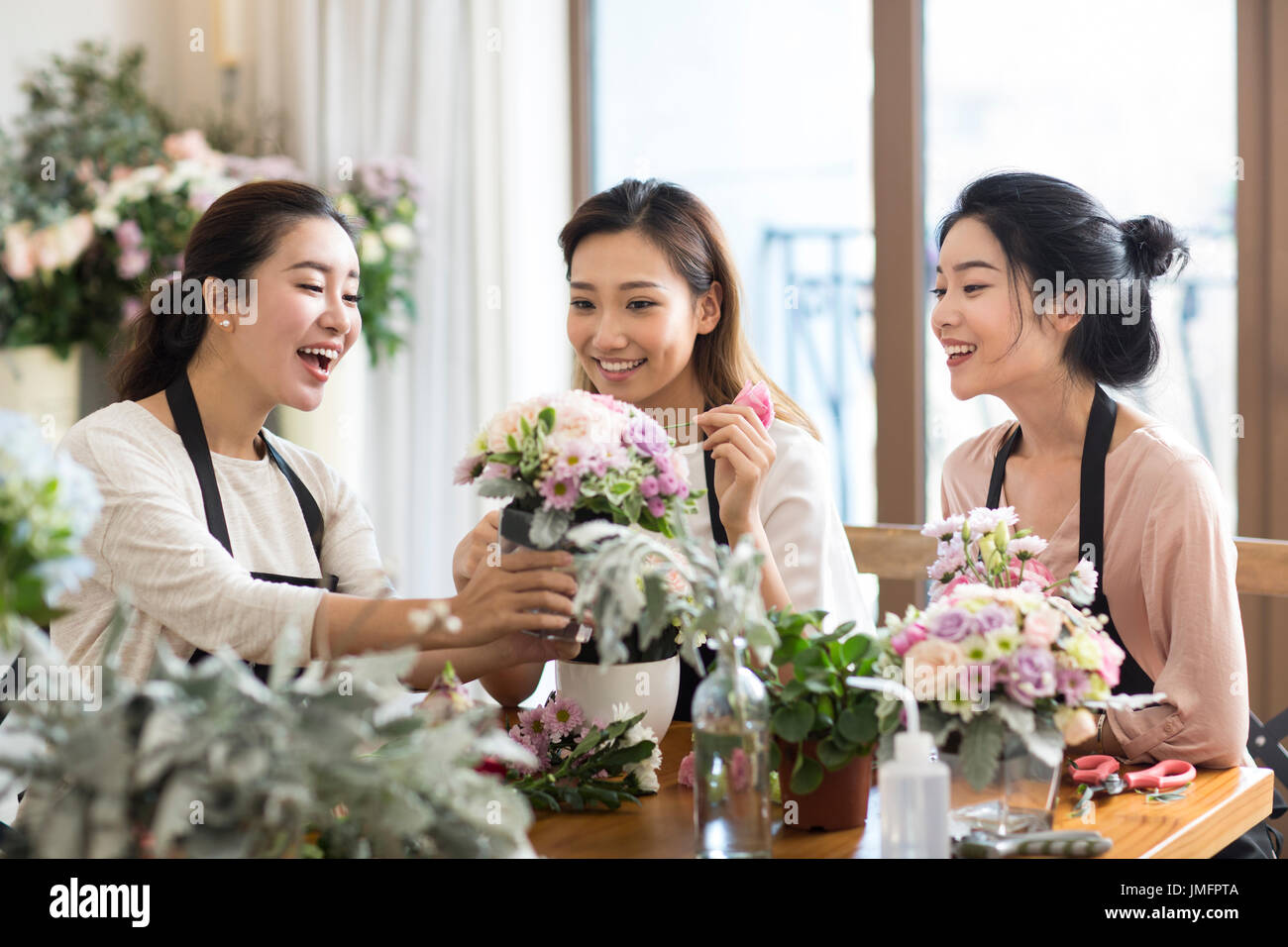 Young women learning flower arrangement Stock Photo - Alamy