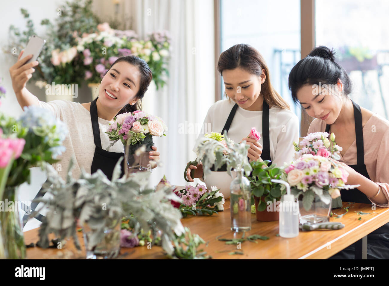 Young women learning flower arrangement Stock Photo - Alamy