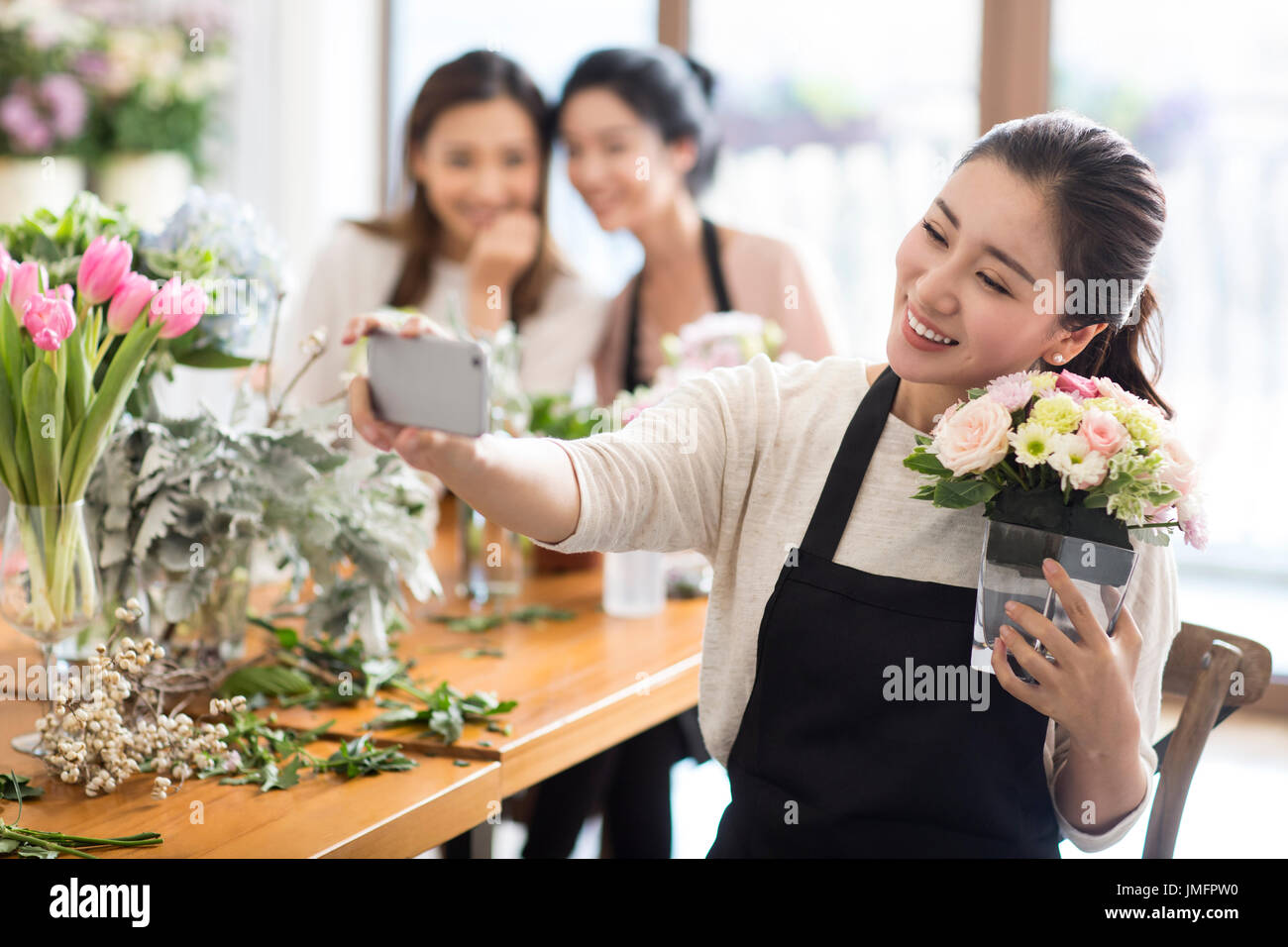 Young women learning flower arrangement Stock Photo - Alamy