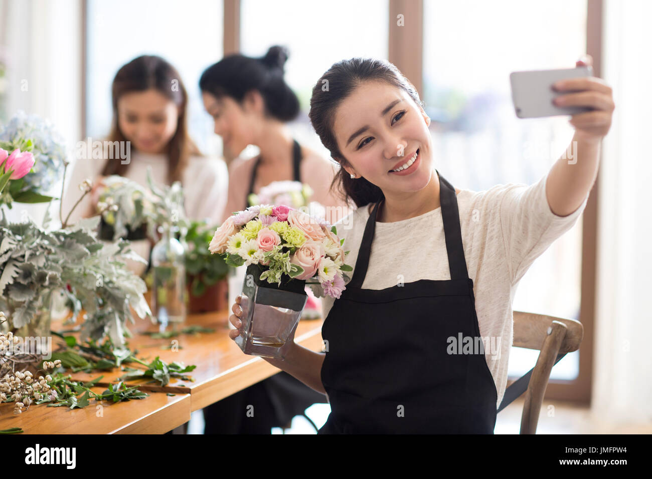 Young women learning flower arrangement Stock Photo - Alamy