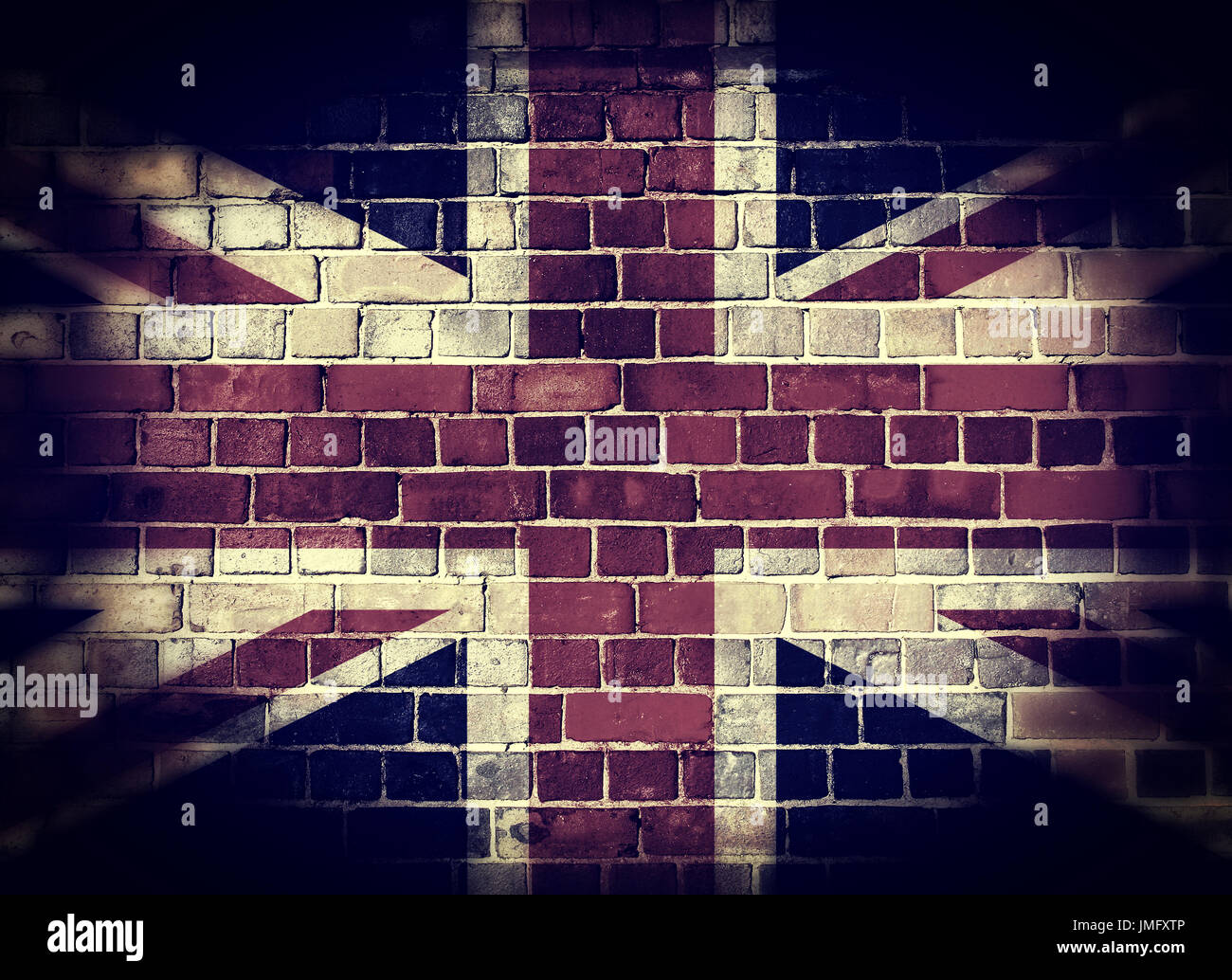 Desaturated Union flag on a brick wall background with a dark vignette ...