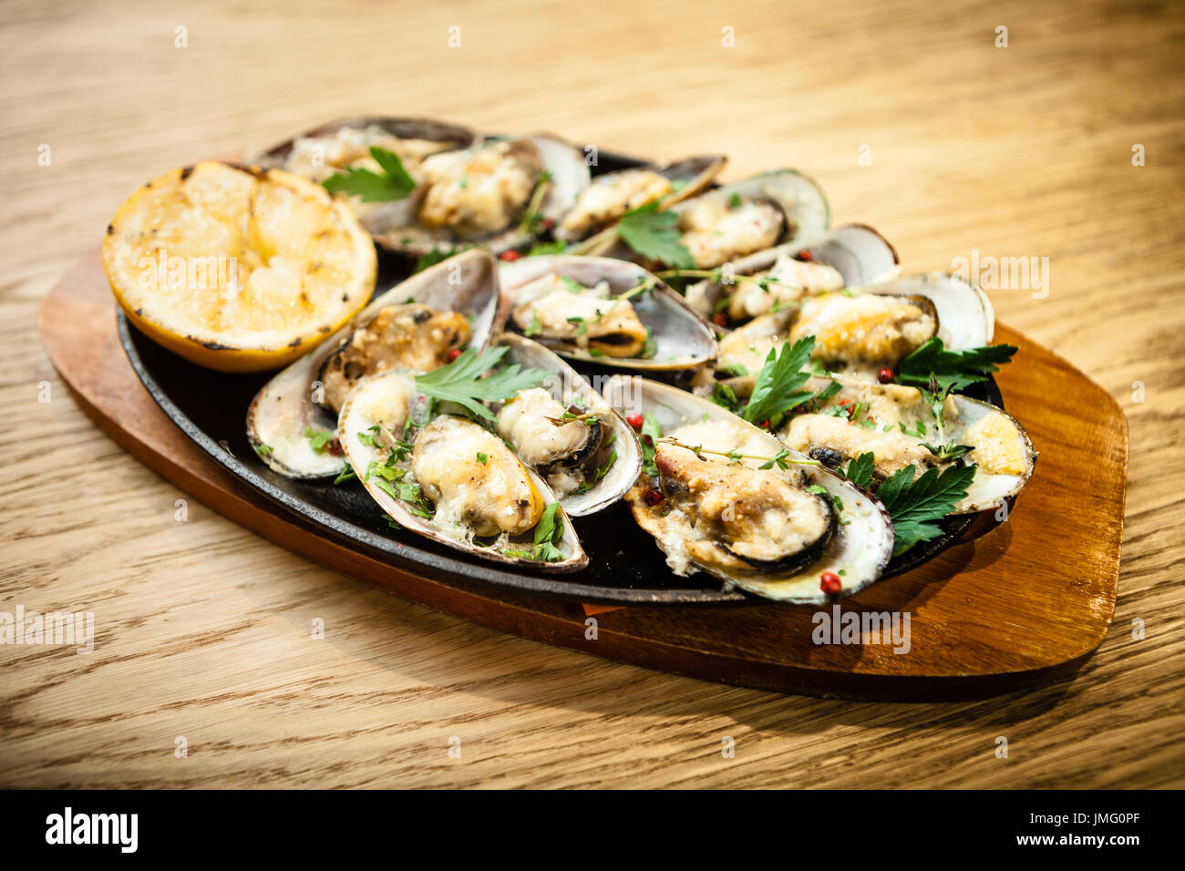 Baked mussels with cheese Stock Photo - Alamy