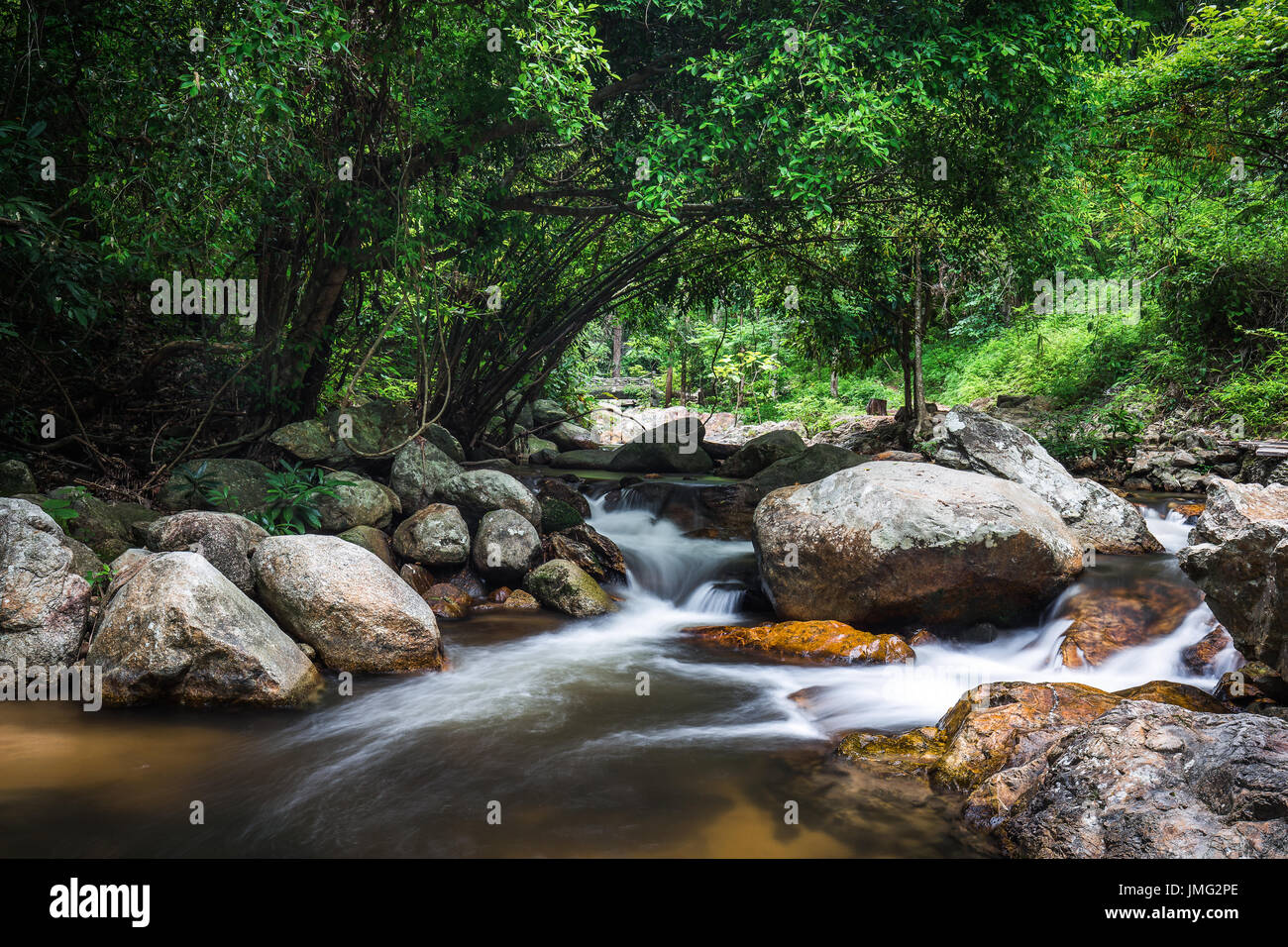 Watercourse of rocks river with smooth flowing water inside tropical ...