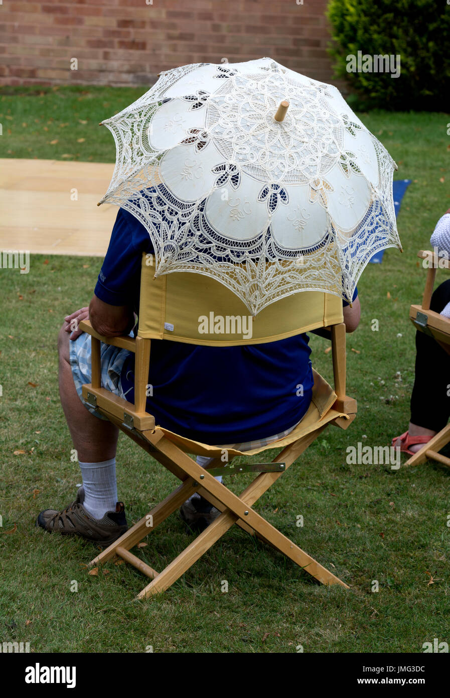 Person under parasol hi-res stock photography and images - Alamy